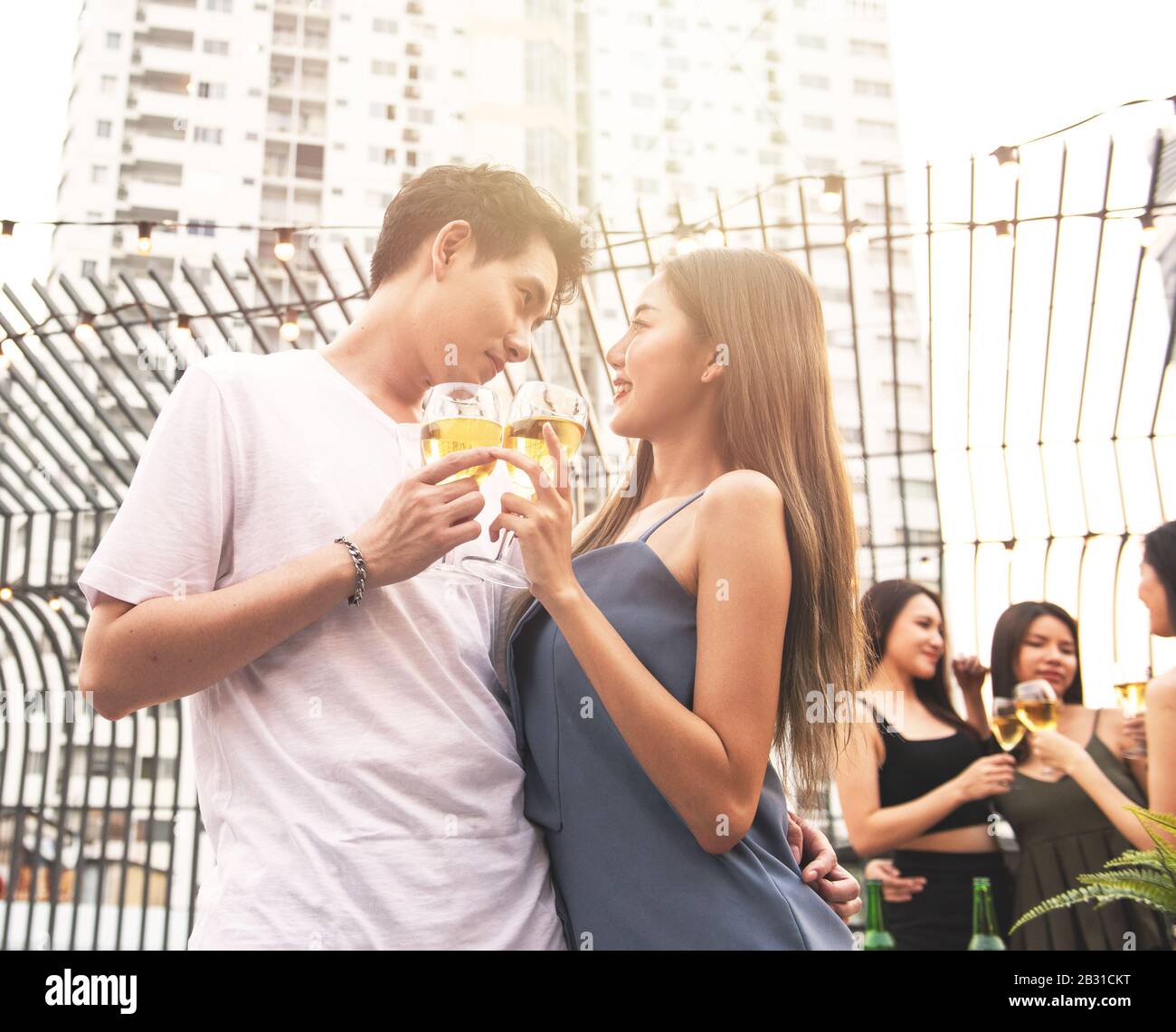 Young asian couple lover have fun dancing and drinking in night party ...