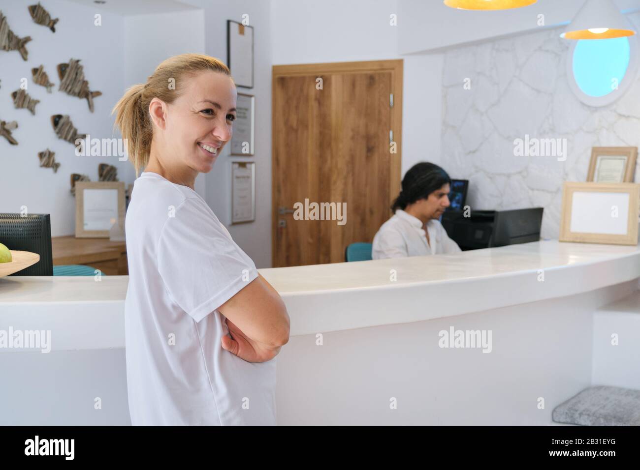 Portrait of spa hotel workers, woman near reception Stock Photo - Alamy