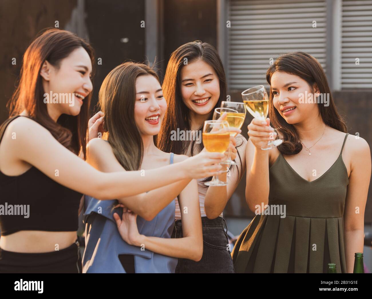 Group of young beautiful happy asian women holding bottle of beer chat ...