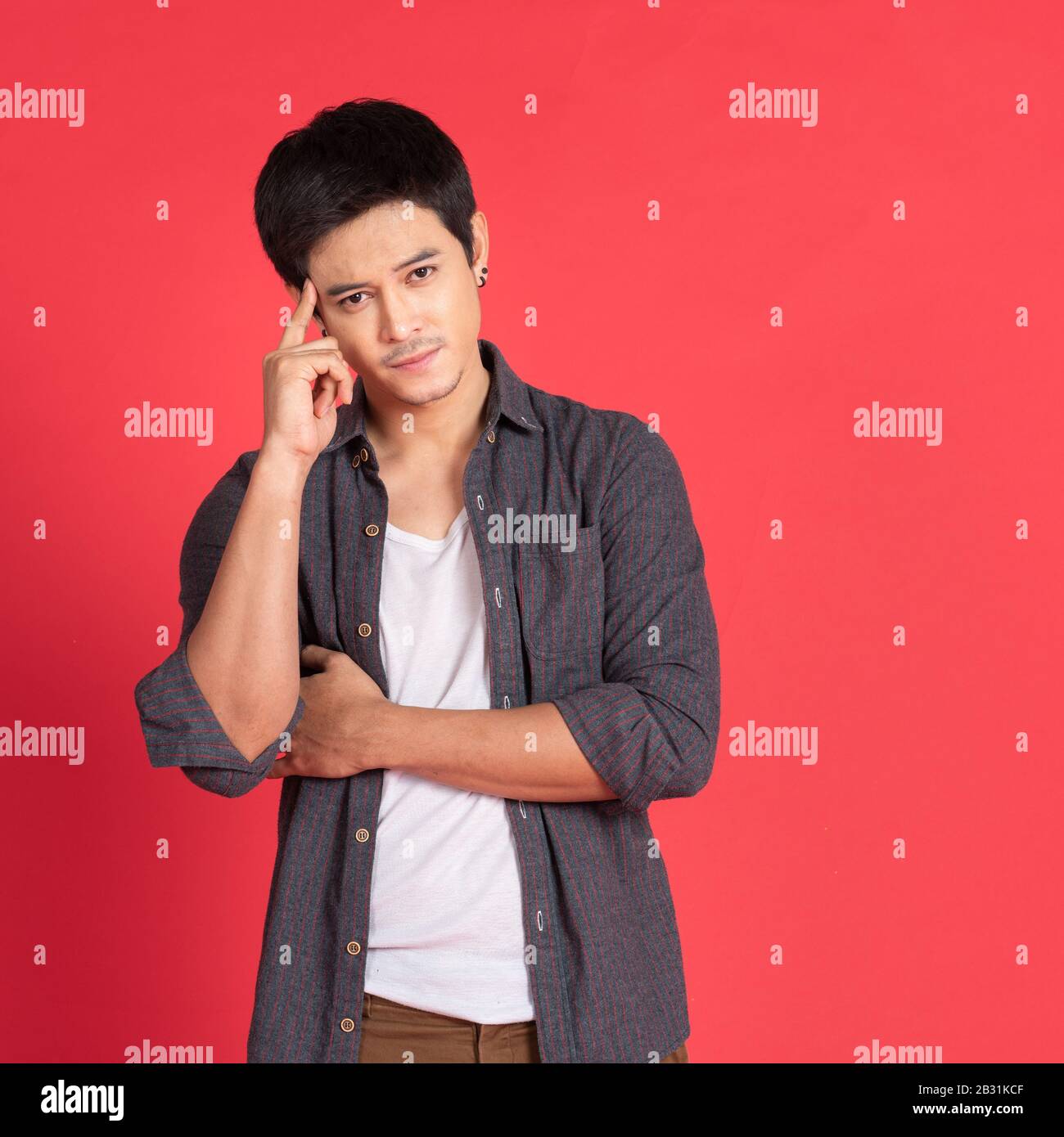 Young cool handsome asian man looking sideways with doubtful and ...