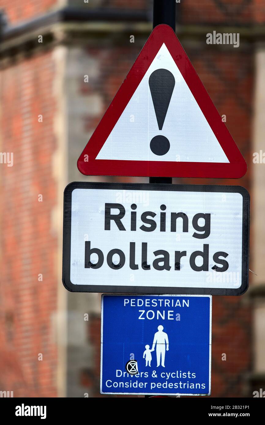 Warning notice to drivers and cyclists of rising bollards and a ...