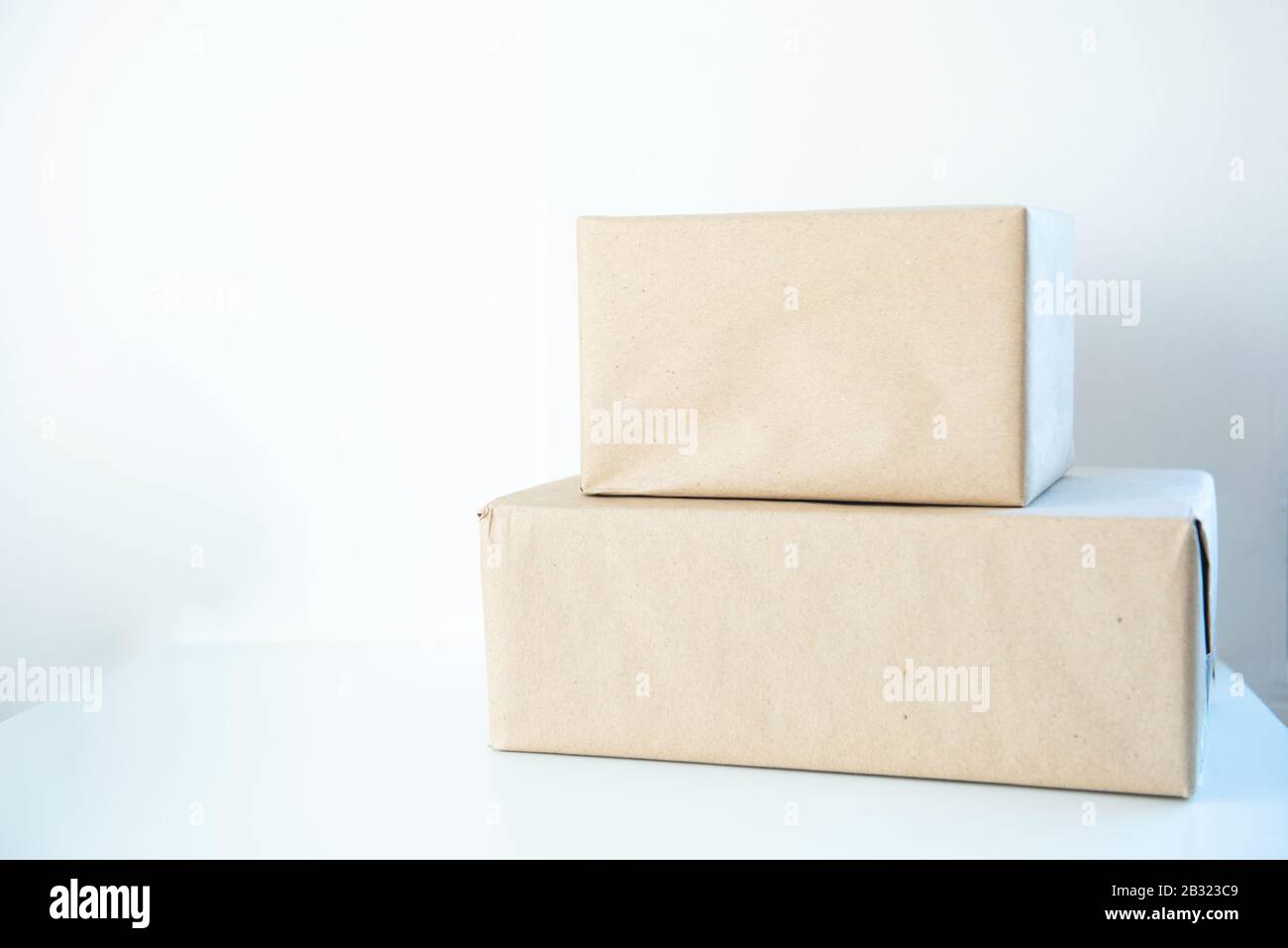 pile of two corrugated cardboard carton parcels box stacked on table ...