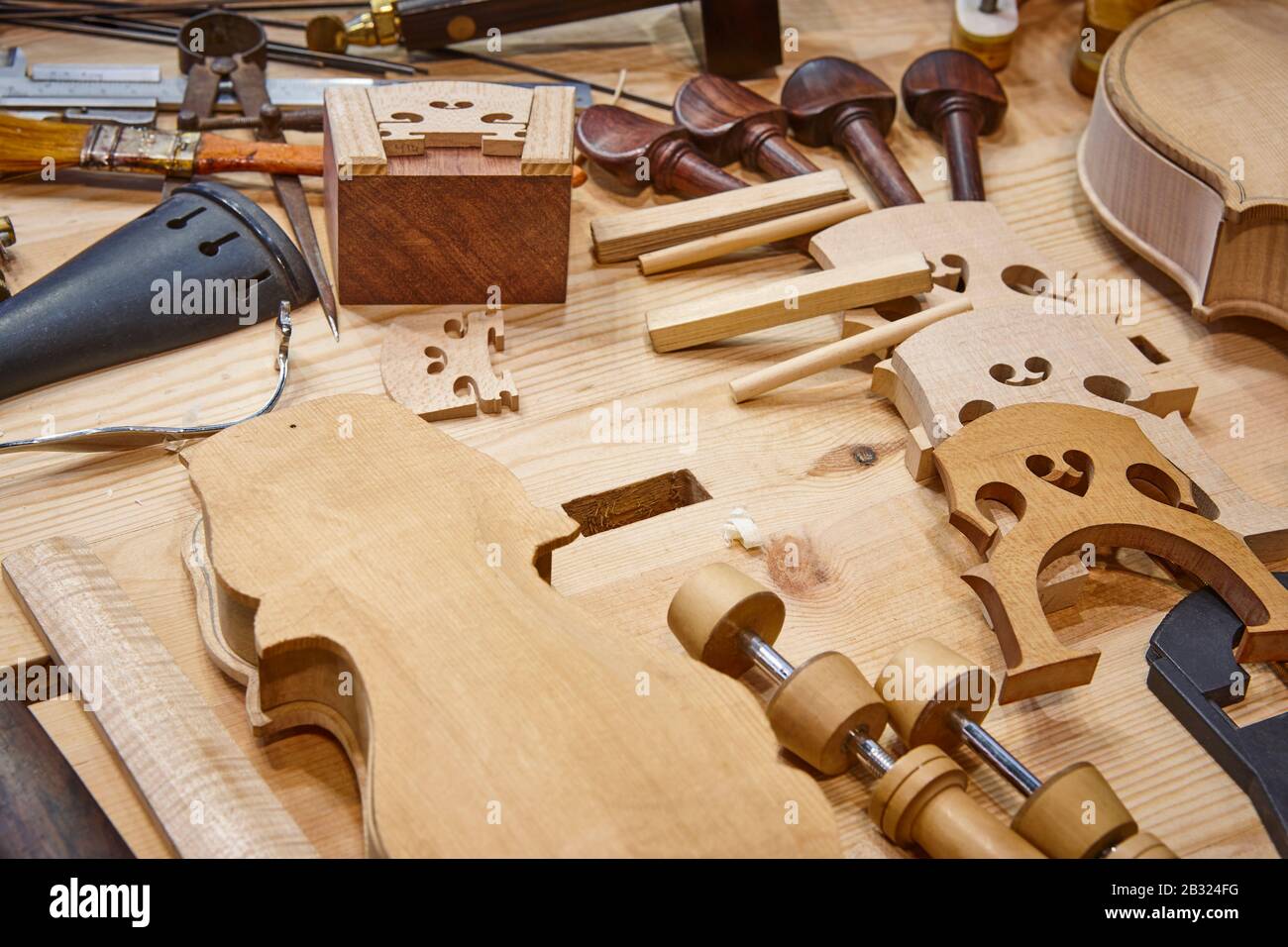 Luthier workshop with violin wooden parts and tools. Traditional ...