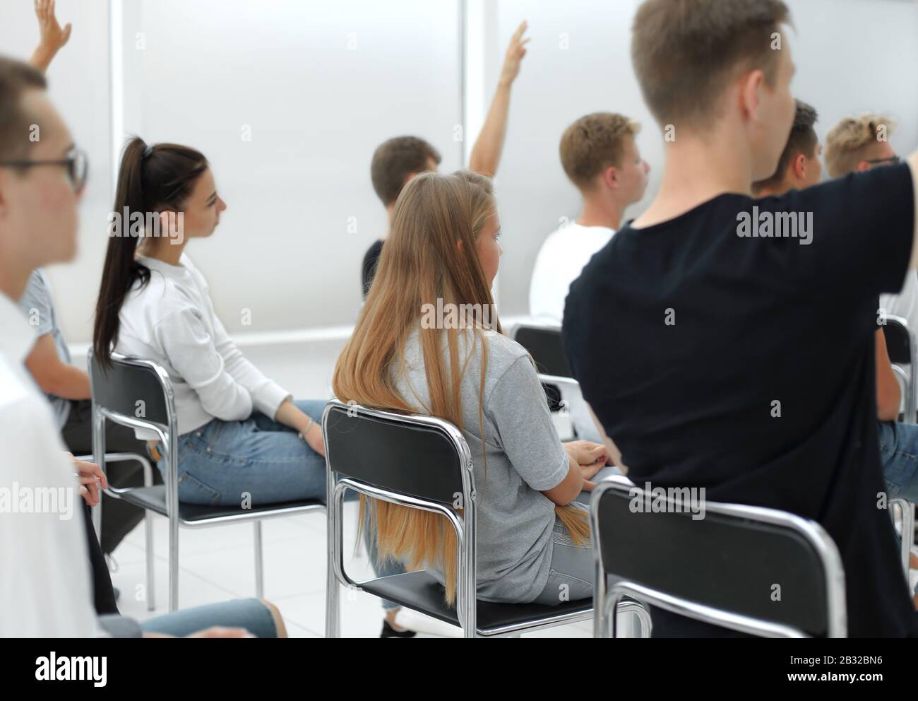 diverse young people applauding while sitting in the same row Stock ...