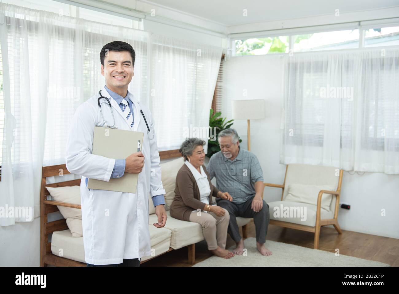 Young handsome caucasian male doctor standing hand holding document ...