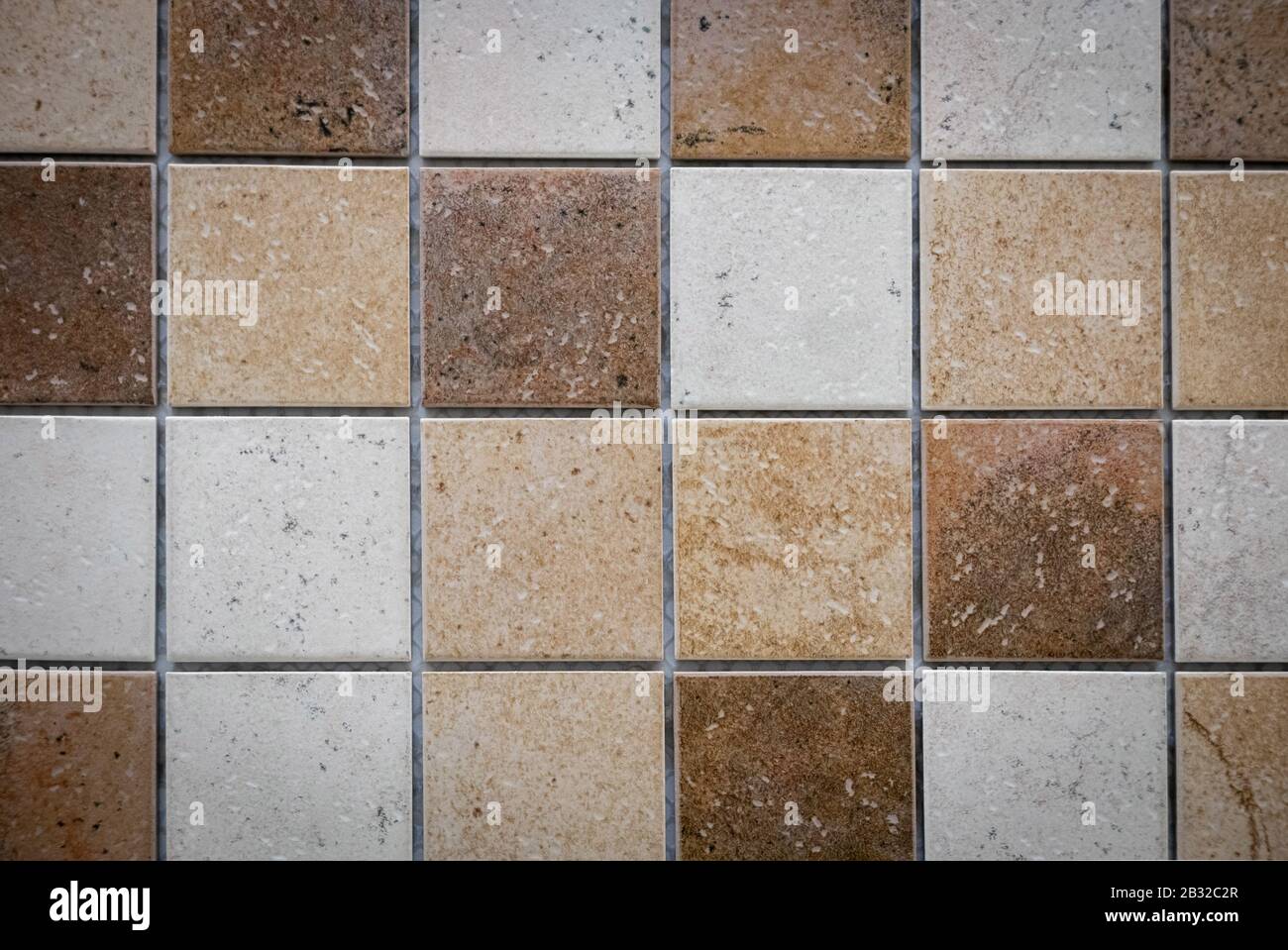 Brown ceramic mosaic on the wall as background Stock Photo - Alamy