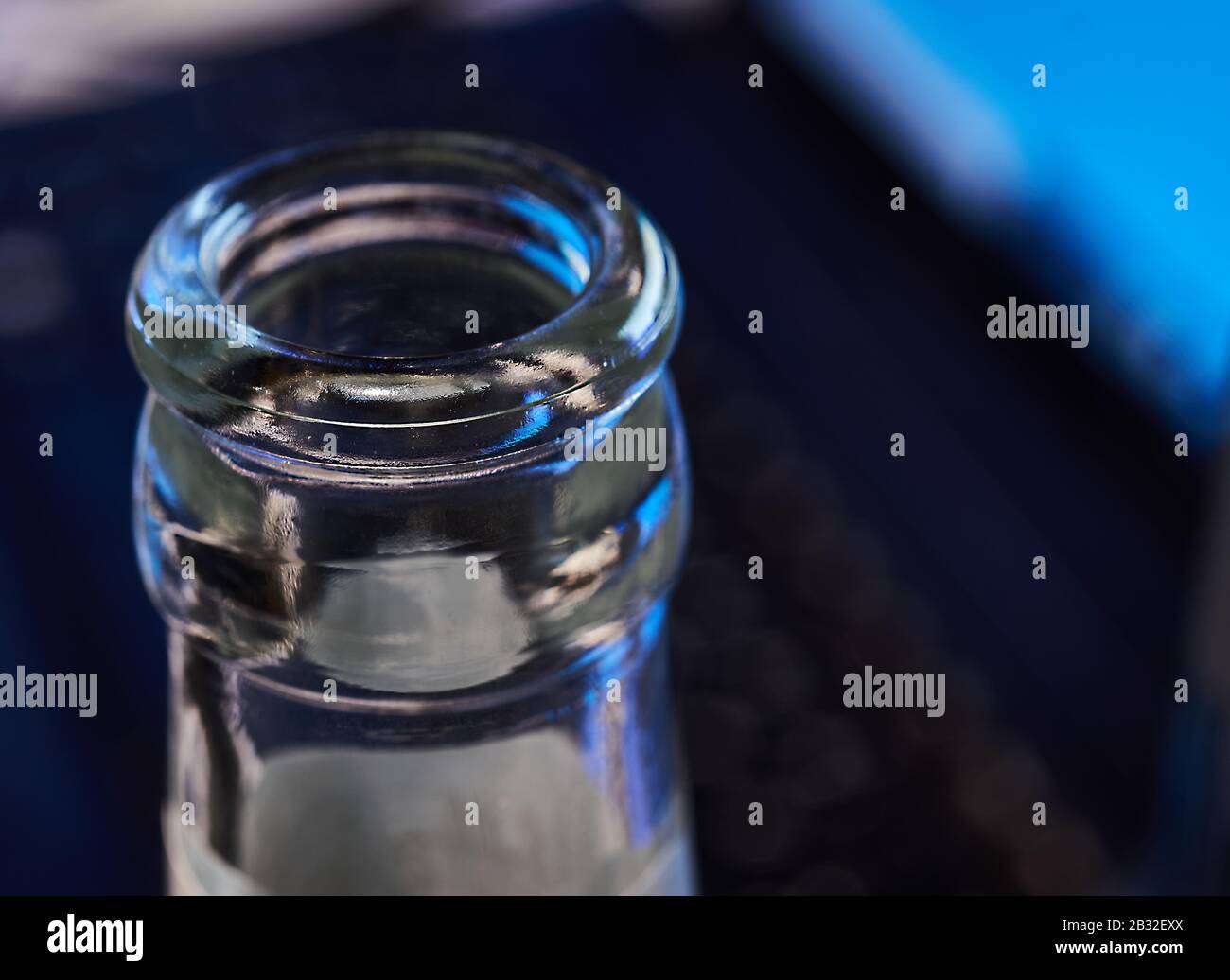 Empty beer bottle, upper part, in front of the keyboard of a laptop ...
