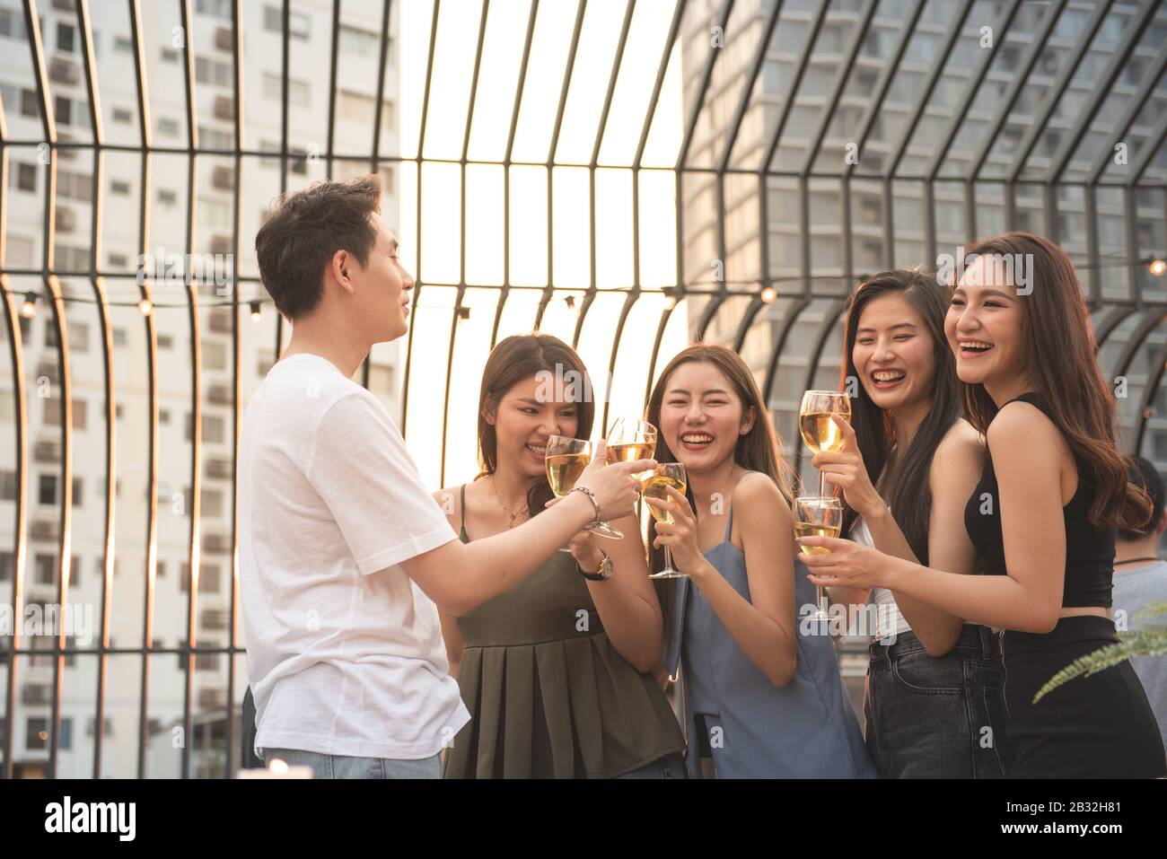 Group of asian multiple gender holding glass of wine chat together with ...