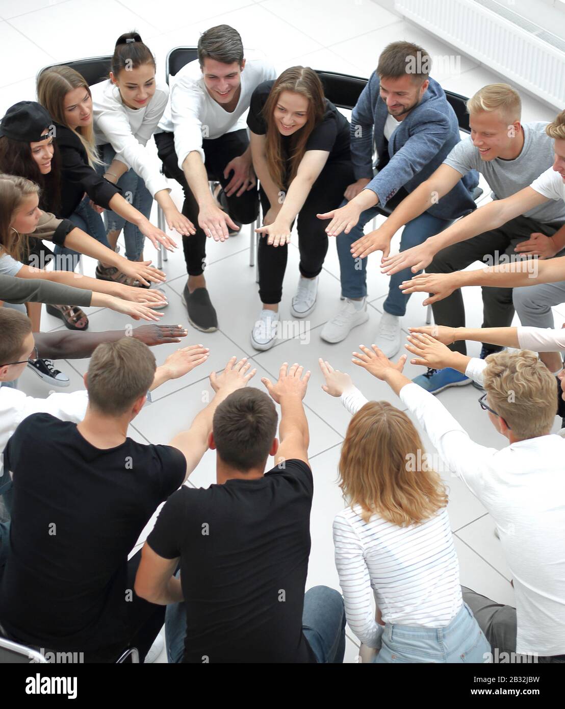 group of diverse young people putting their hands togethe Stock Photo ...