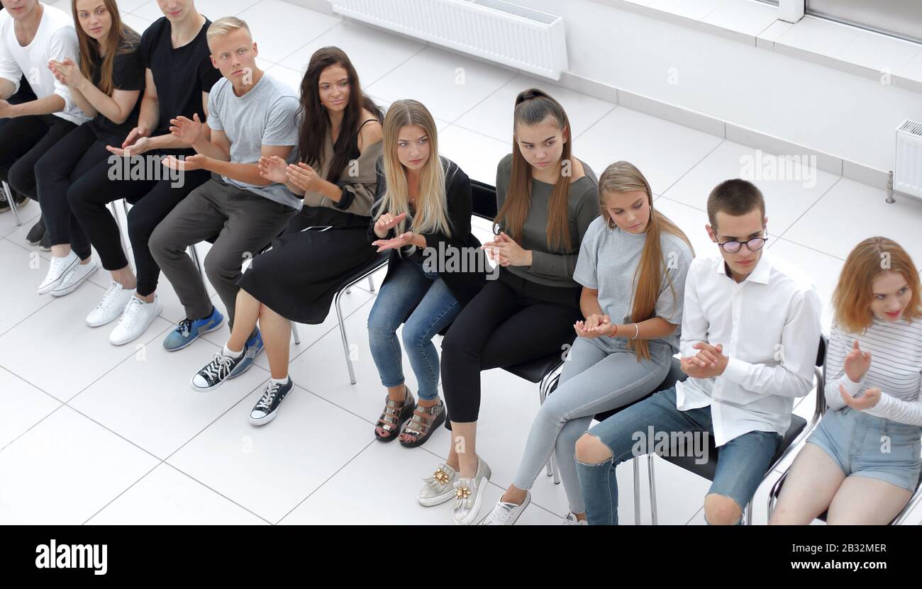 young listeners of business training sitting in one row Stock Photo - Alamy