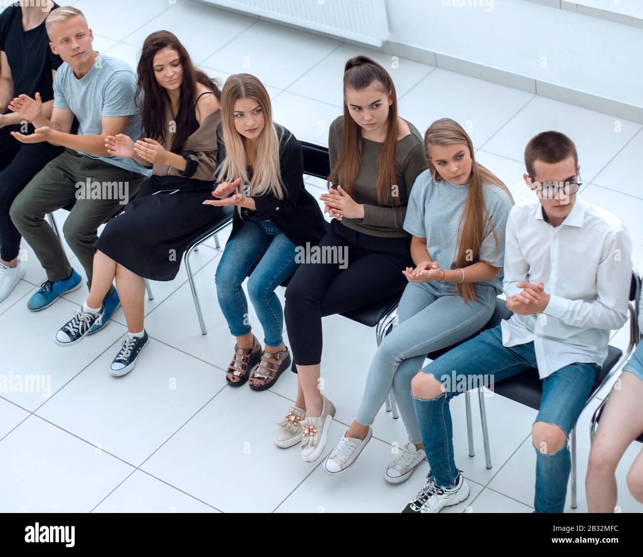 young listeners of business training sitting in one row Stock Photo - Alamy