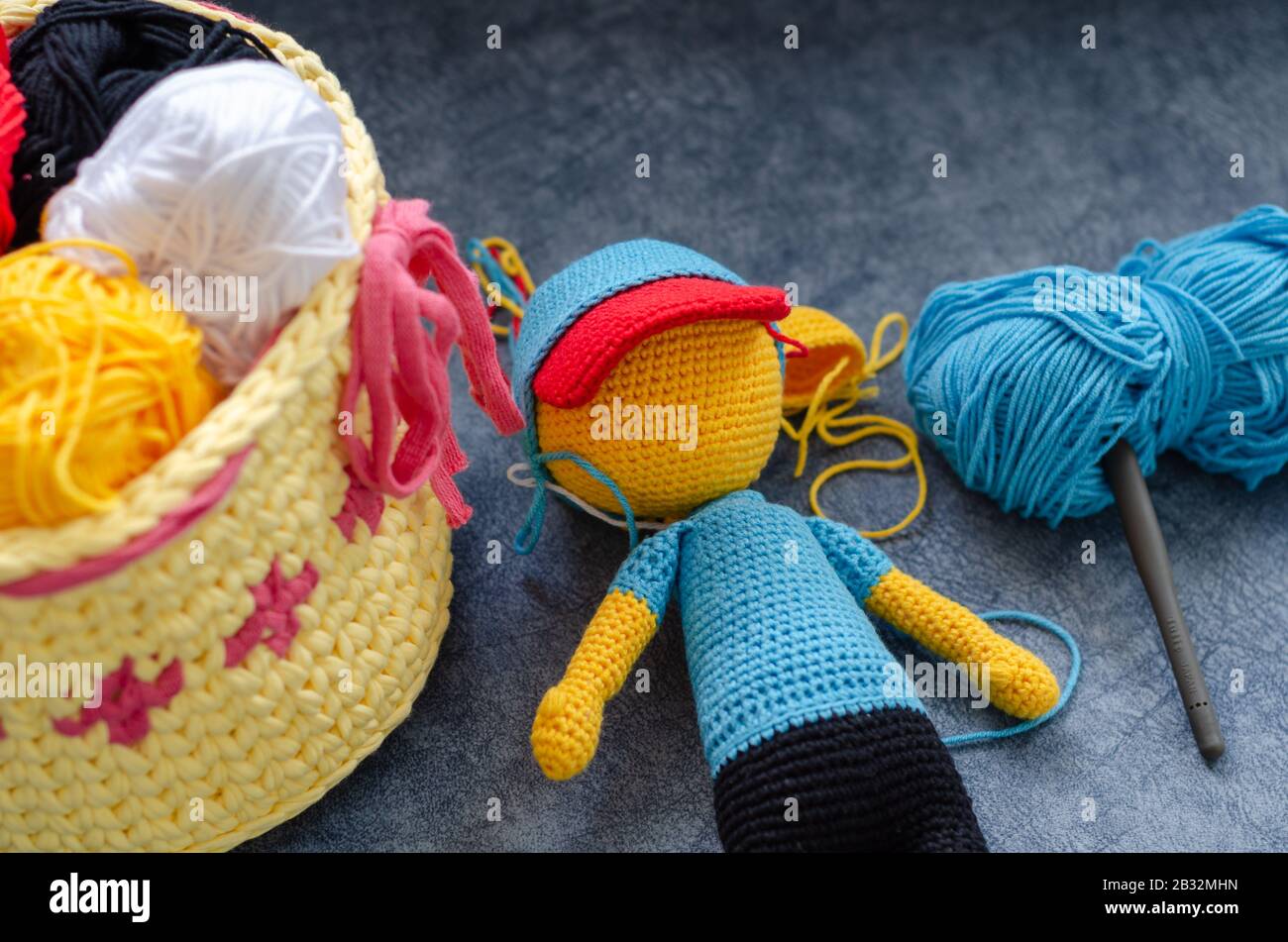 Amigurumi toy and colorful threads on blue background Stock Photo - Alamy