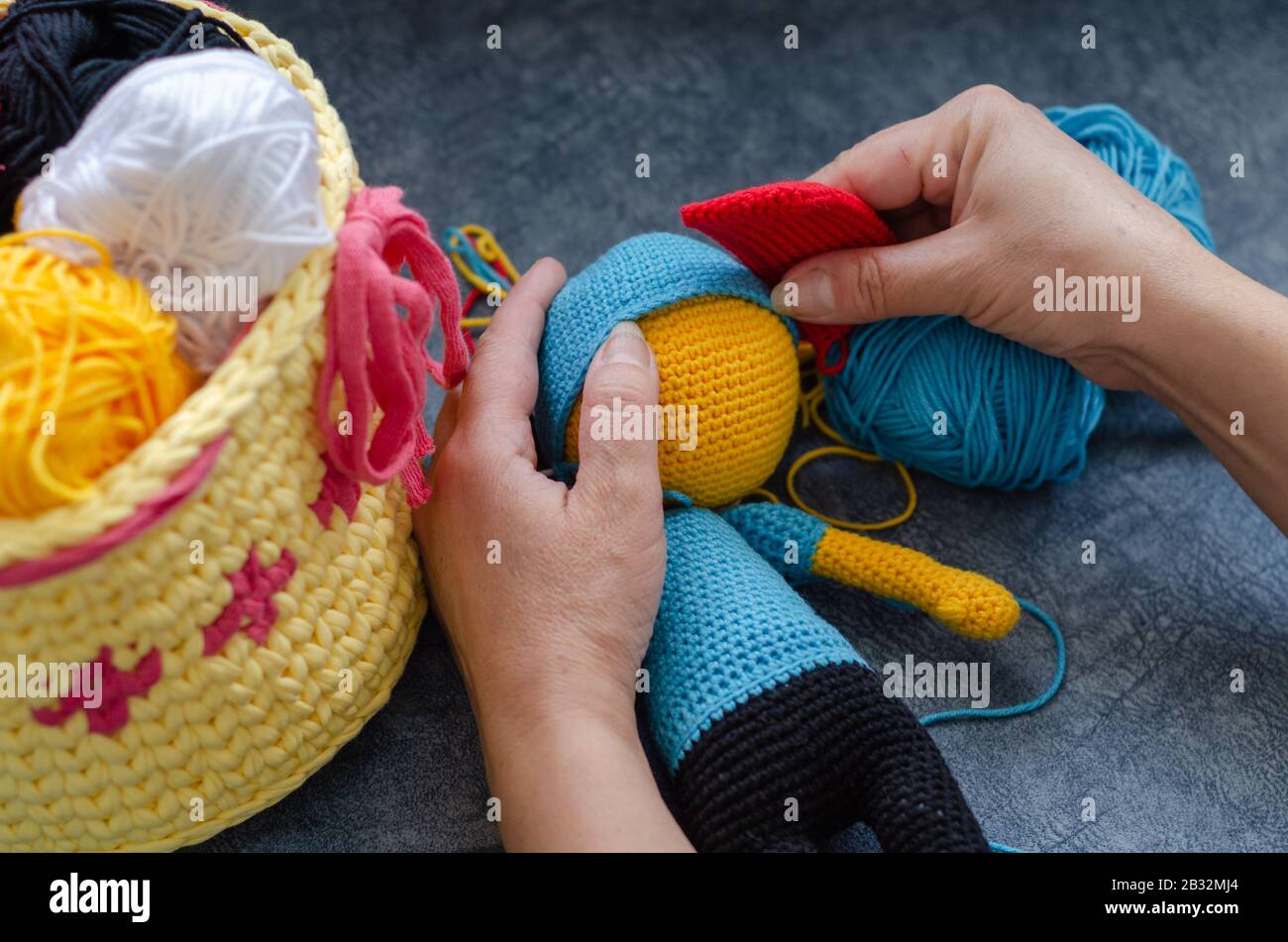 Amigurumi toy and colorful threads on blue background Stock Photo - Alamy