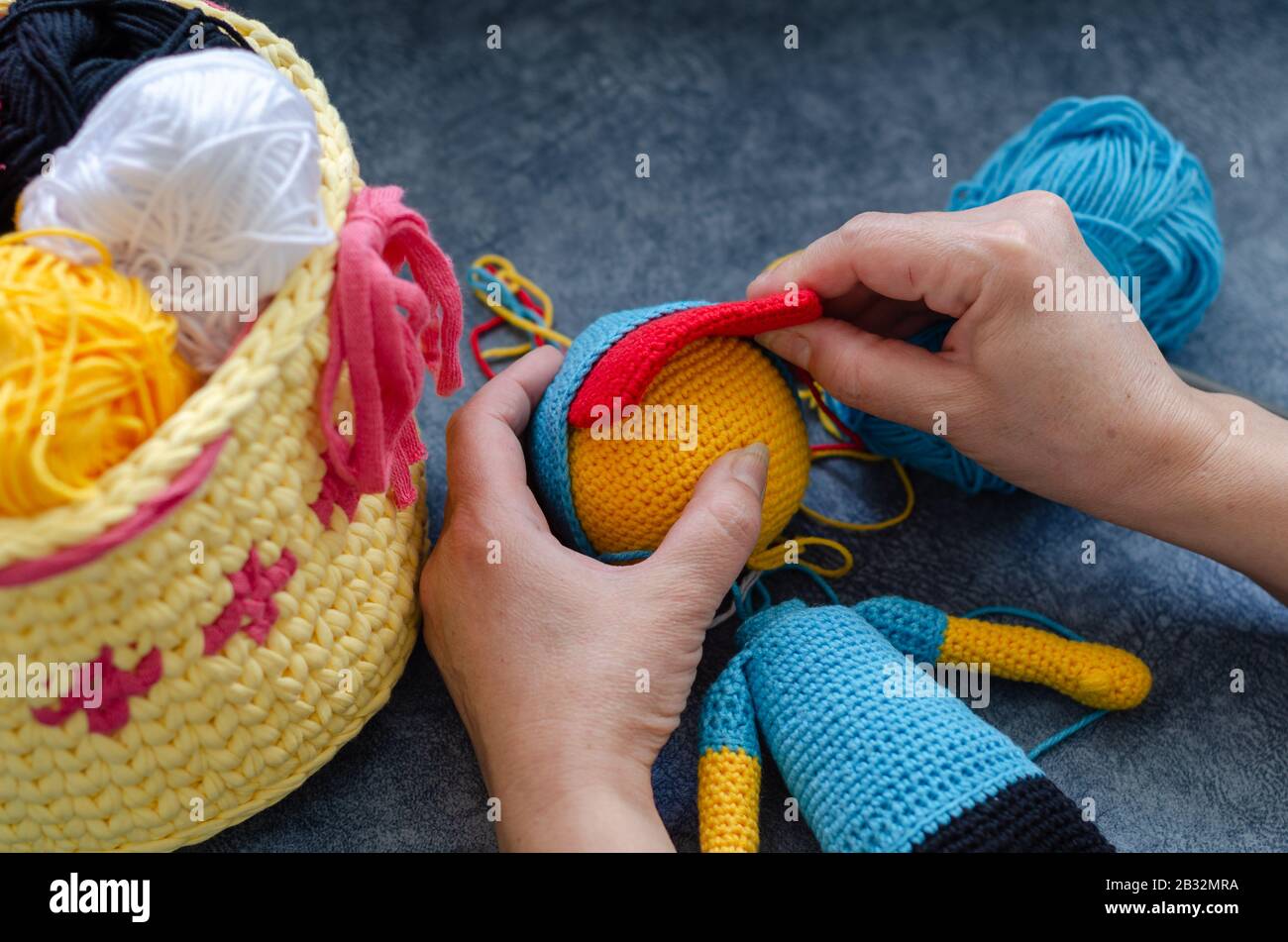 Amigurumi toy and colorful threads on blue background Stock Photo - Alamy
