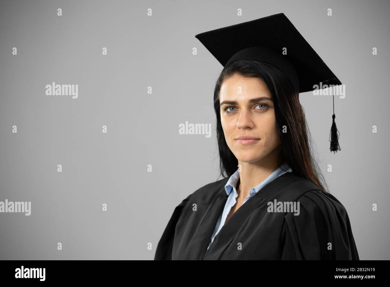 Portrait of a Caucasian female student holding a certificate graduating ...
