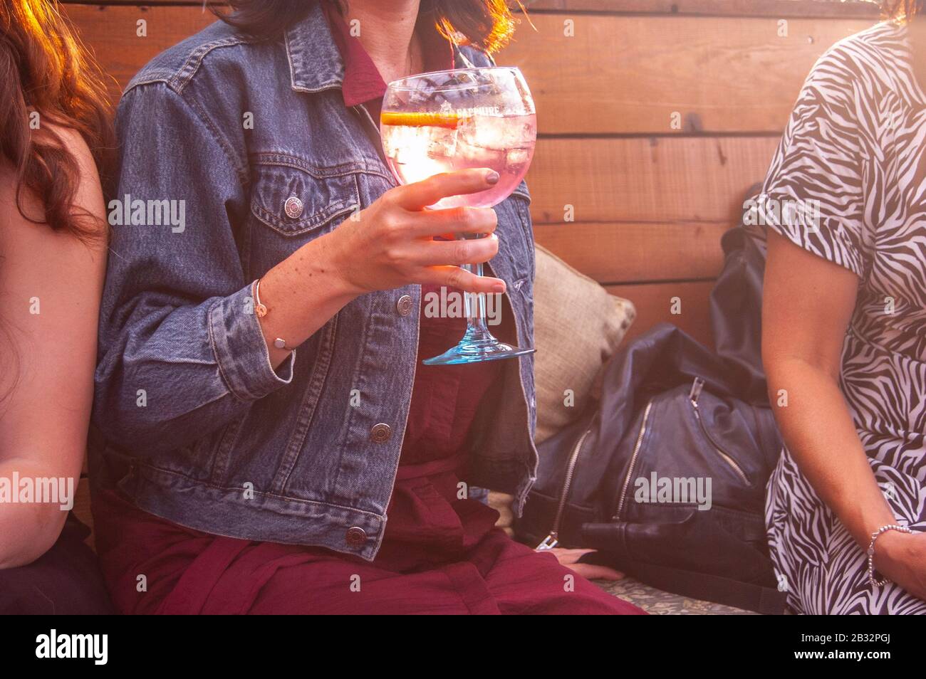 Woman drinking pink gin in summertime Stock Photo - Alamy