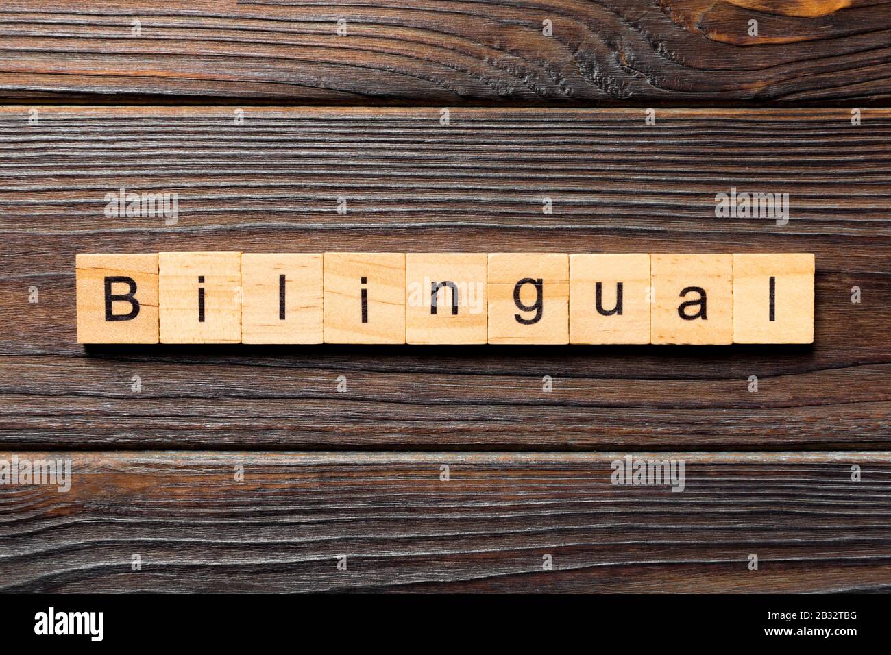 Bilingual word written on wood block. Bilingual text on wooden table ...