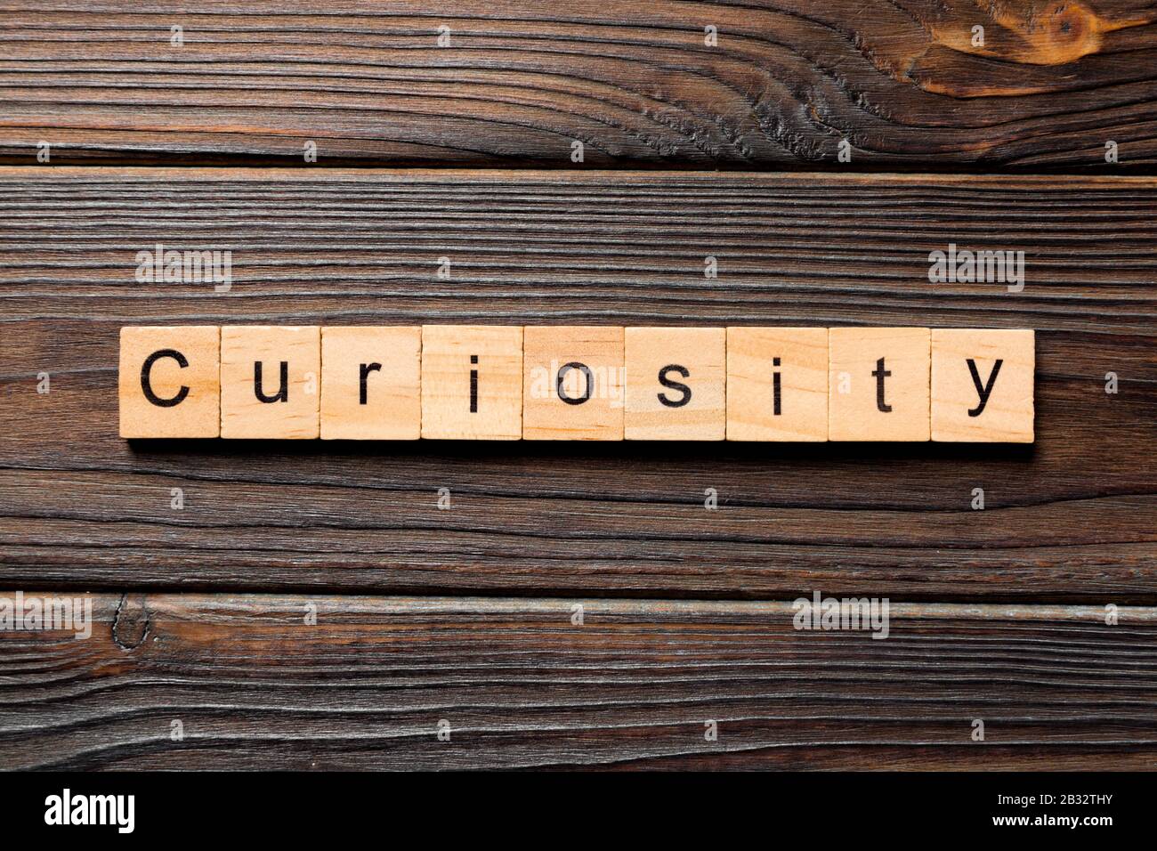 curiosity word written on wood block. curiosity text on table, concept ...