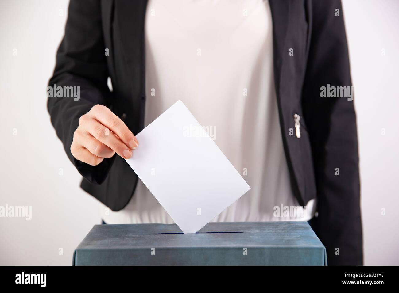 Hand of a voter putting vote in the ballot box. Election concept Stock ...