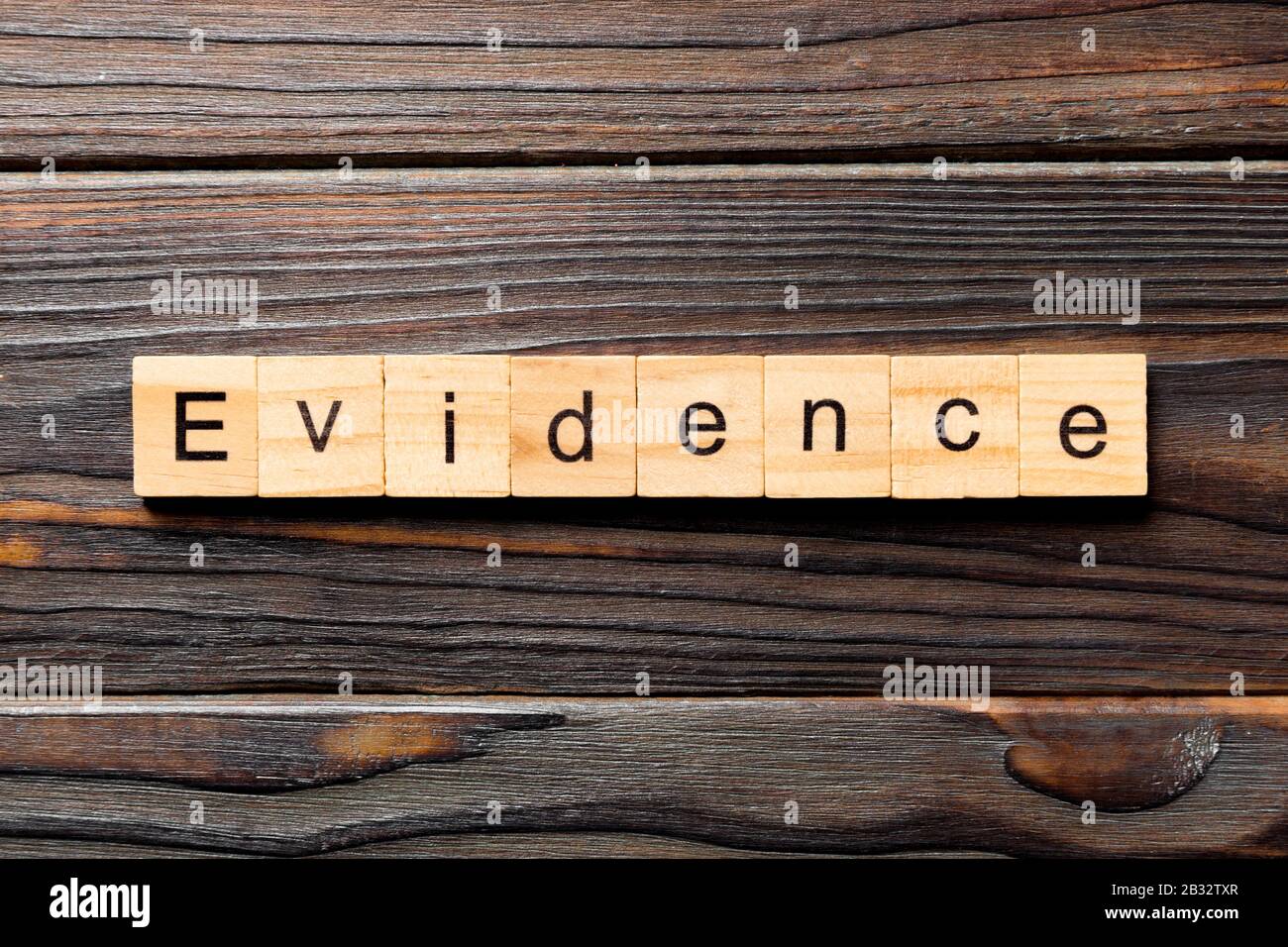 evidence word written on wood block. evidence text on table, concept ...
