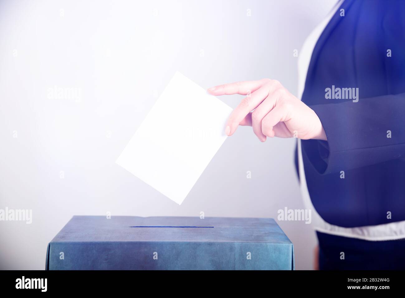 Hand of a voter putting vote in the ballot box. Election concept Stock ...