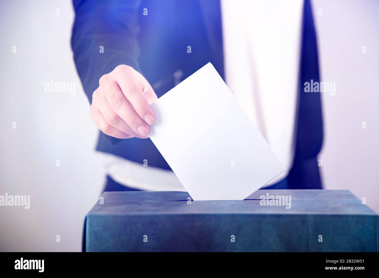 Hand of a voter putting vote in the ballot box. Election concept Stock ...