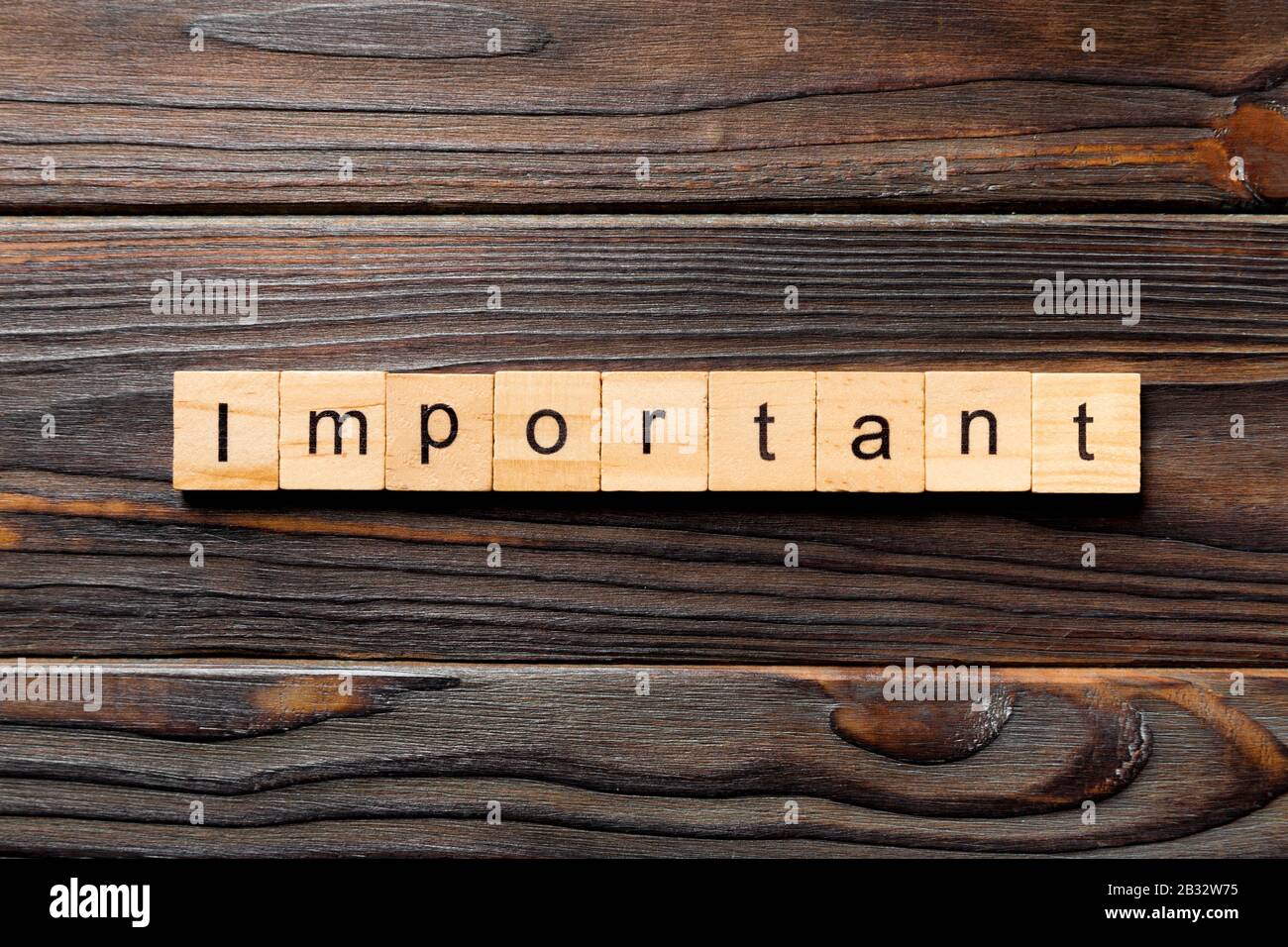 important word written on wood block. important text on wooden table ...
