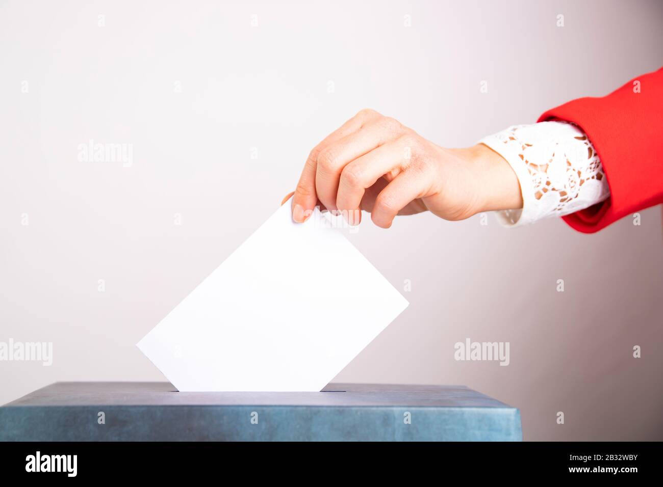 Hand of a voter putting vote in the ballot box. Election concept Stock ...