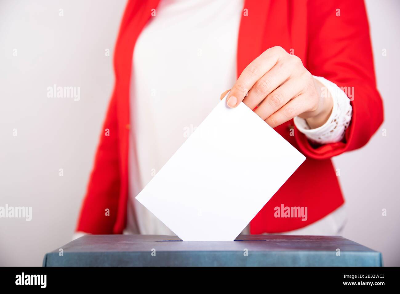Hand of a voter putting vote in the ballot box. Election concept Stock ...