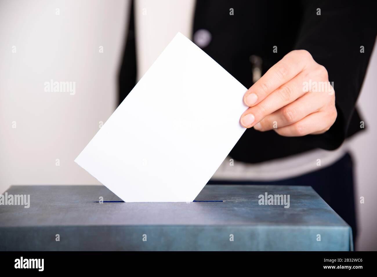 Hand of a voter putting vote in the ballot box. Election concept Stock ...