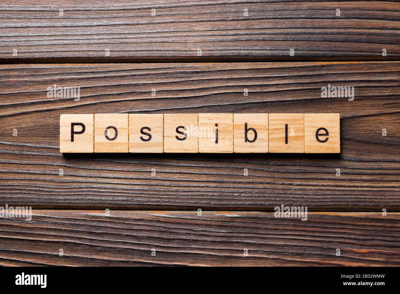 possible word written on wood block. possible text on table, concept ...