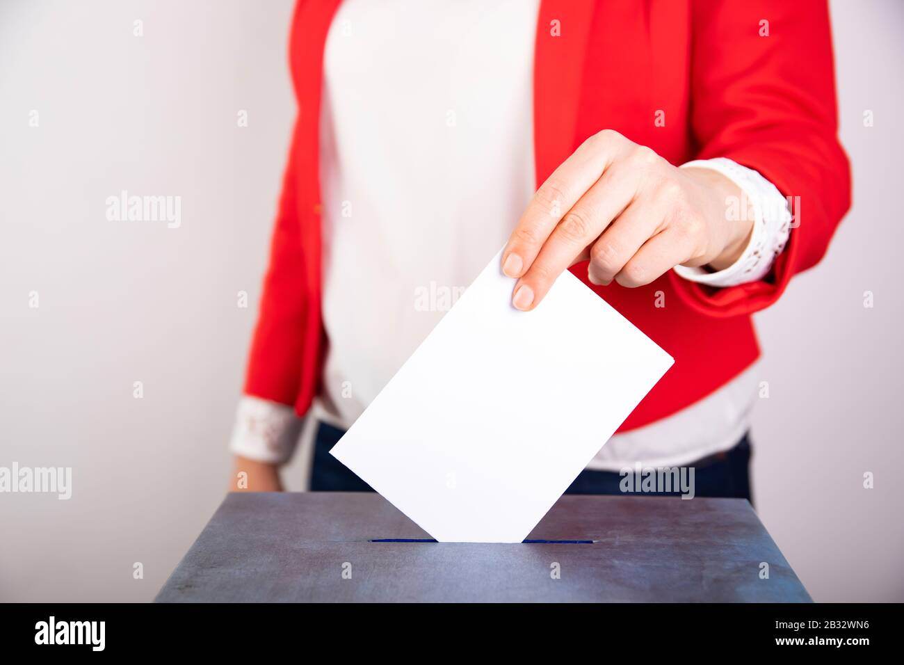 Hand of a voter putting vote in the ballot box. Election concept Stock ...