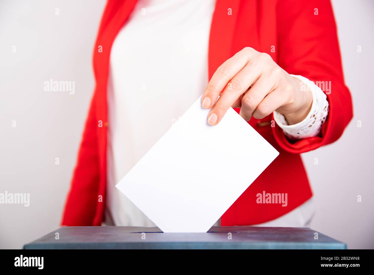 Hand of a voter putting vote in the ballot box. Election concept Stock ...