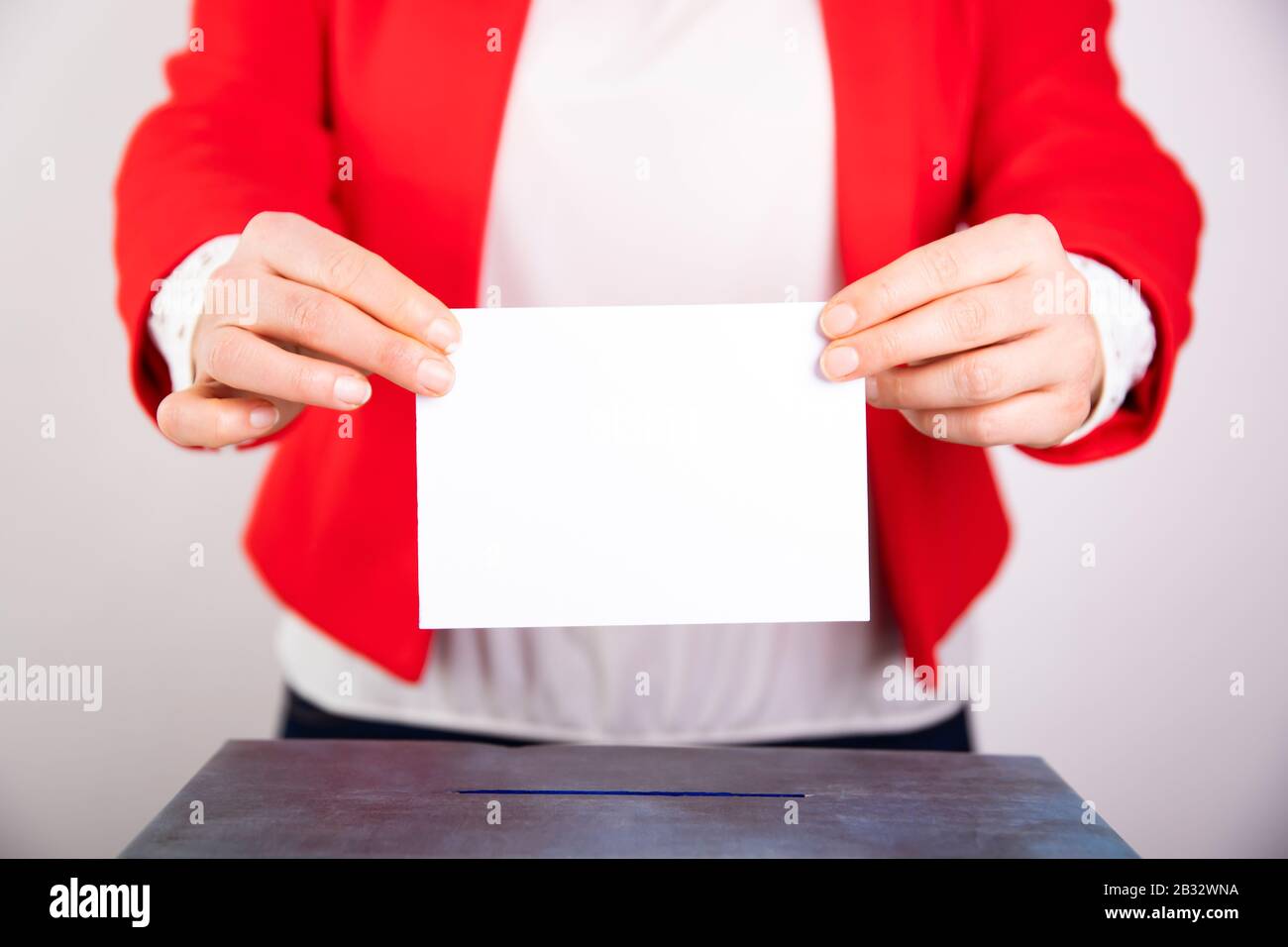 Hand of a voter putting vote in the ballot box. Election concept Stock ...