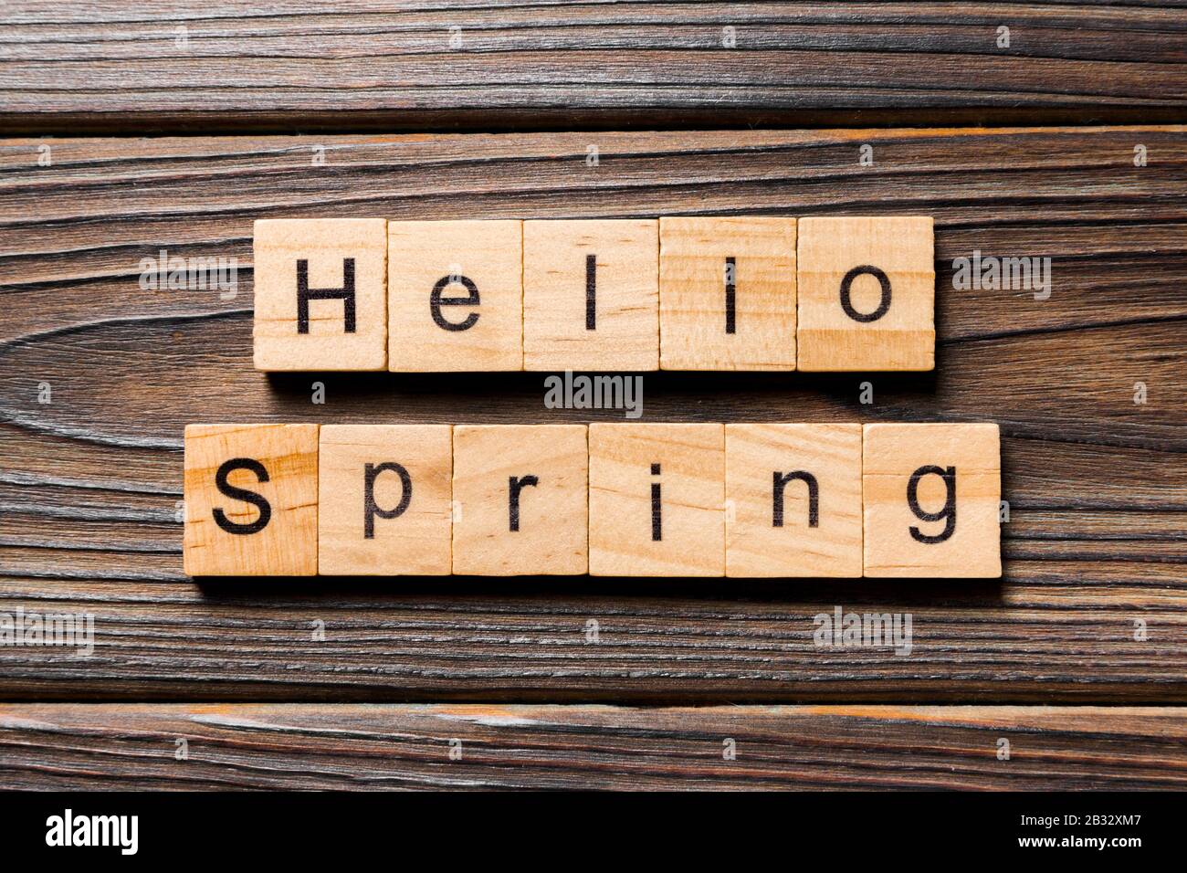 Hello Spring word written on wood block. Hello Spring text on wooden ...