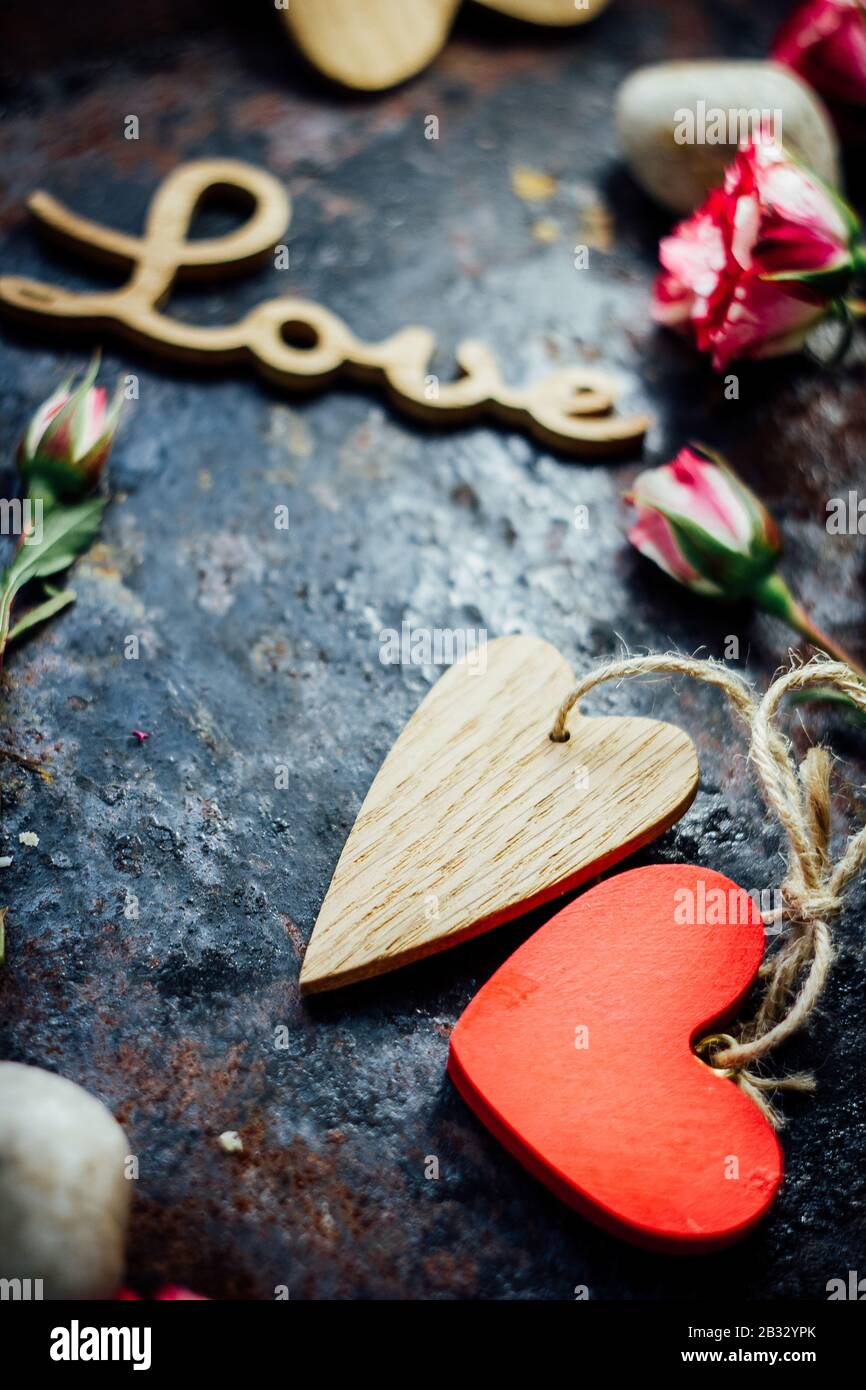 Two bounded hearts on rustic background Stock Photo - Alamy