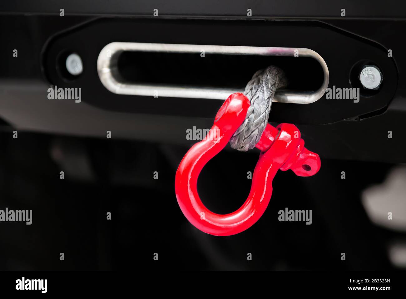 A towing winch with a clevis and a loop on a metal cable mounted on a ...