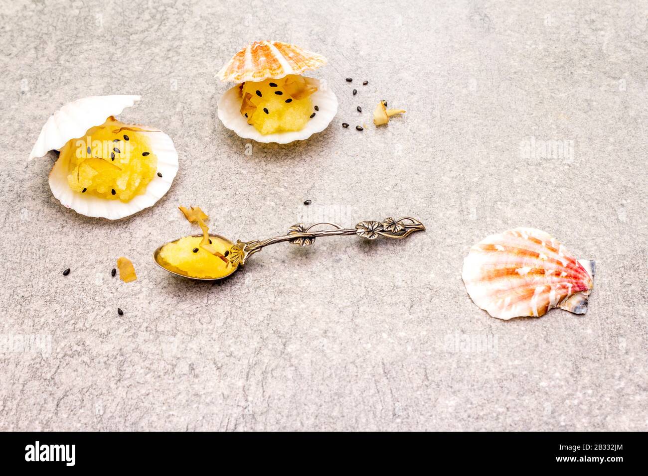 Capelin roe in seashells. Black sesame seeds with bonito flakes ...