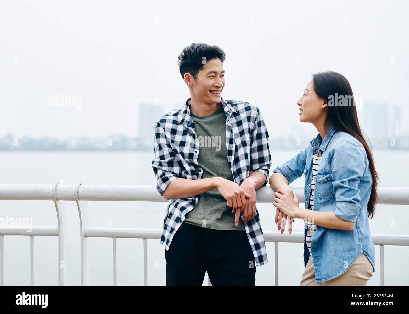 Happy couple having a interesting conversation Stock Photo - Alamy