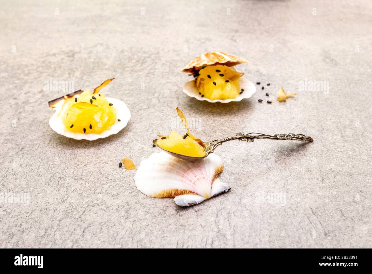 Capelin roe in seashells. Black sesame seeds with bonito flakes ...