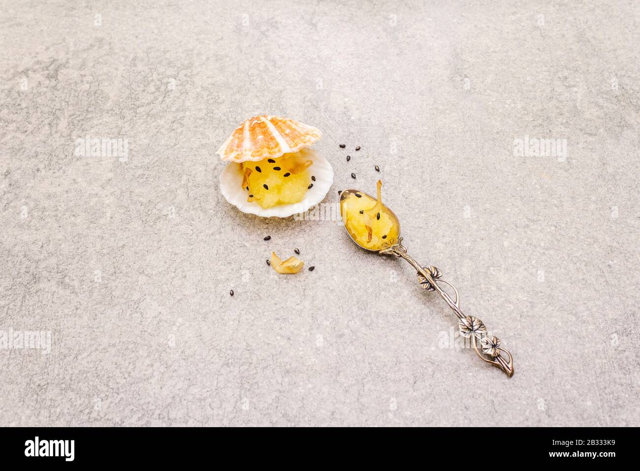 Capelin roe in seashells. Black sesame seeds with bonito flakes ...
