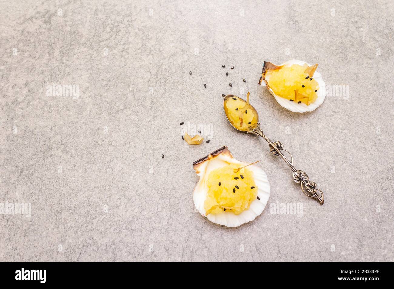 Capelin roe in seashells. Black sesame seeds with bonito flakes ...