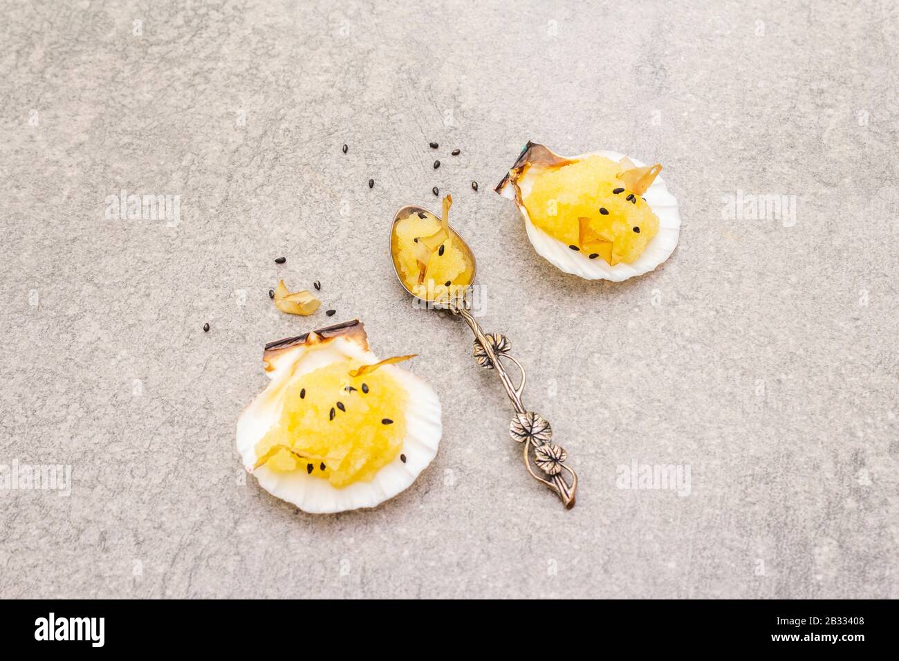 Capelin roe in seashells. Black sesame seeds with bonito flakes ...