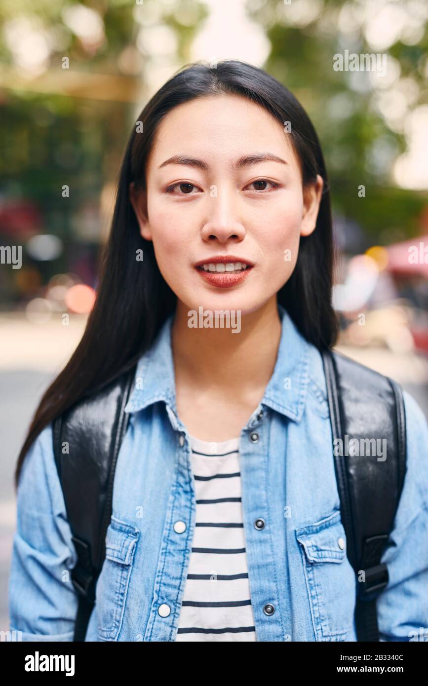 Portrait of Vietnamese young woman with backpack in the city Stock ...