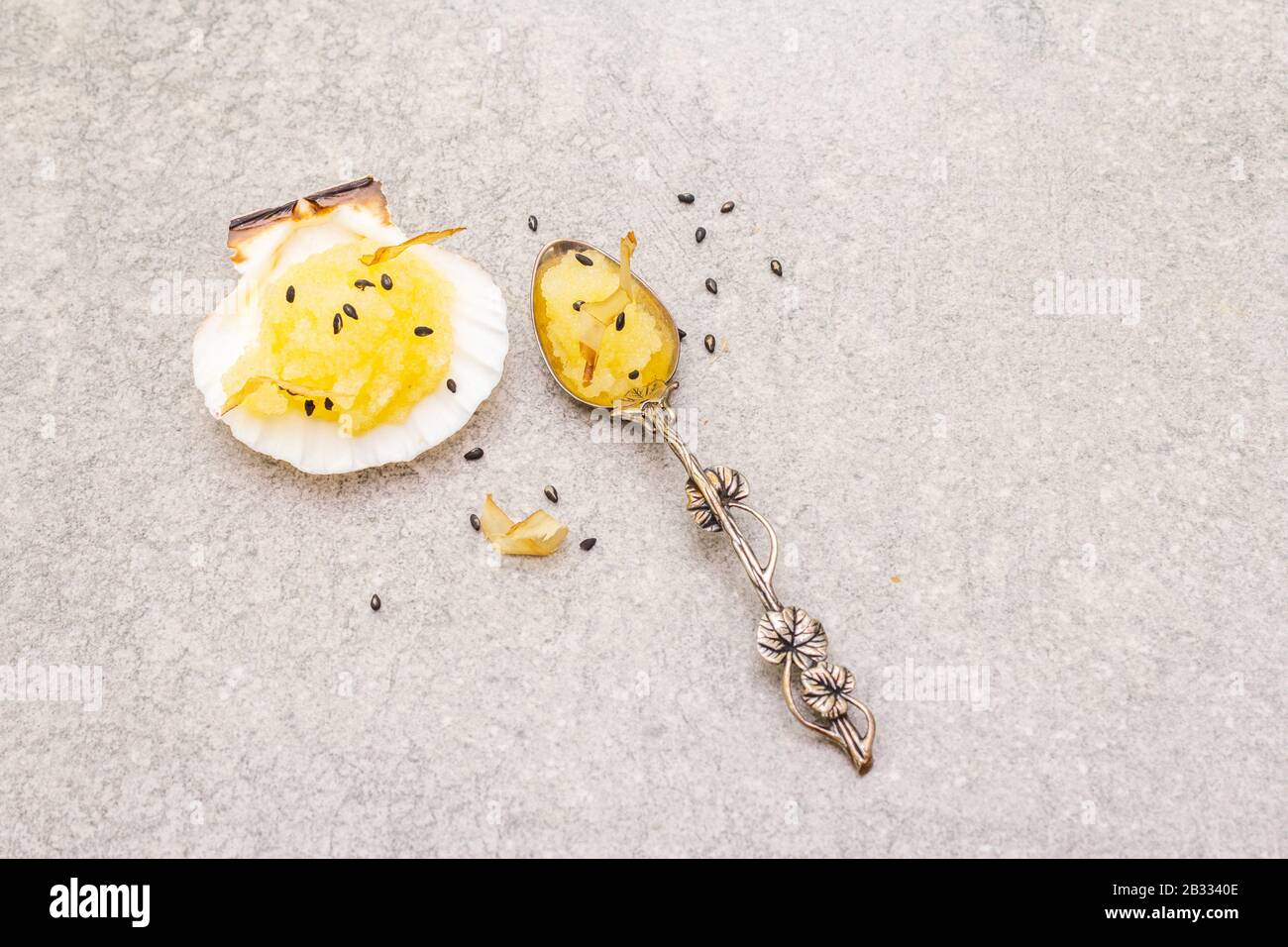 Capelin roe in seashells. Black sesame seeds with bonito flakes ...