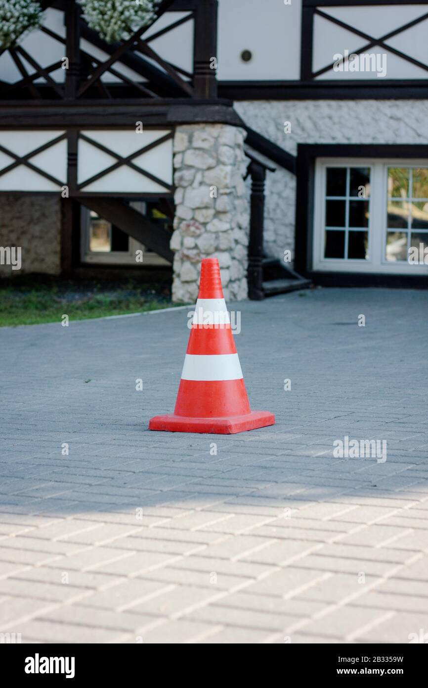 Orange road cone staying at the street Stock Photo - Alamy