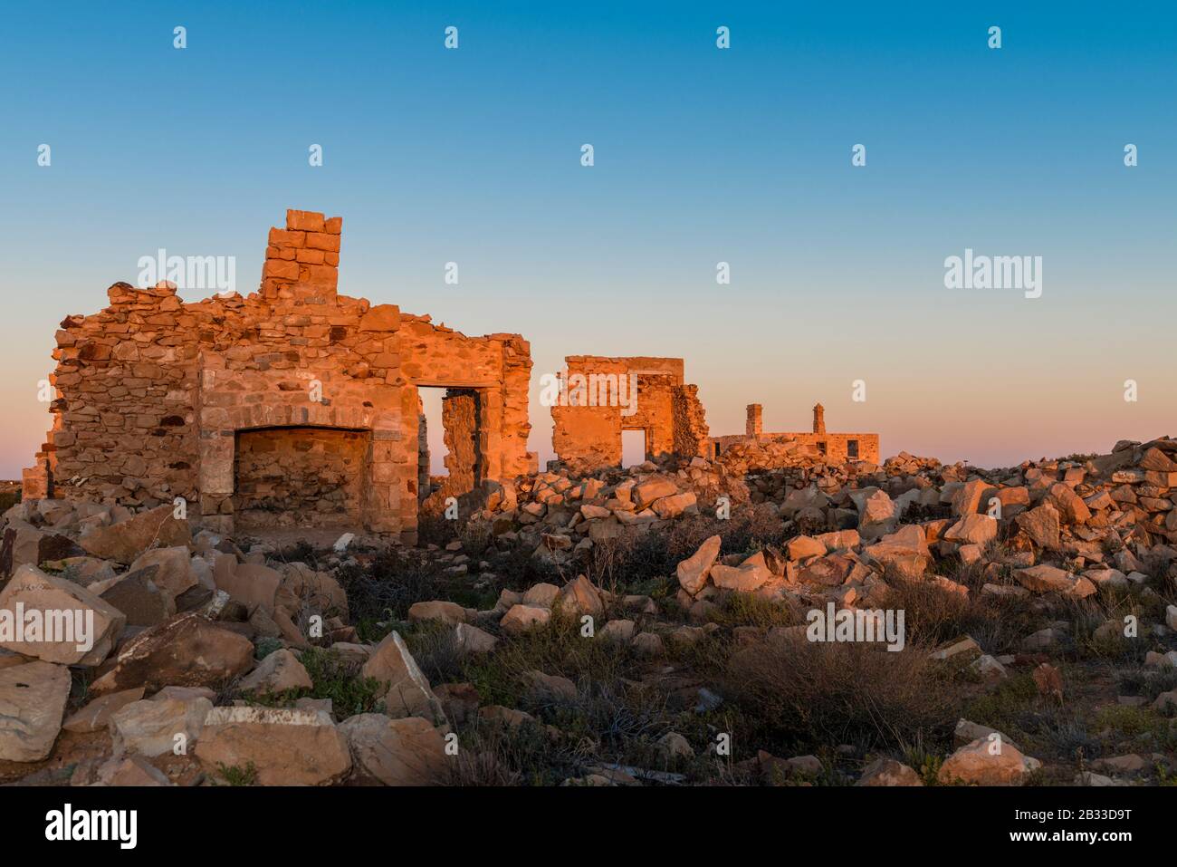 An old ruined building and scattered debris in the ghost town of Farina ...