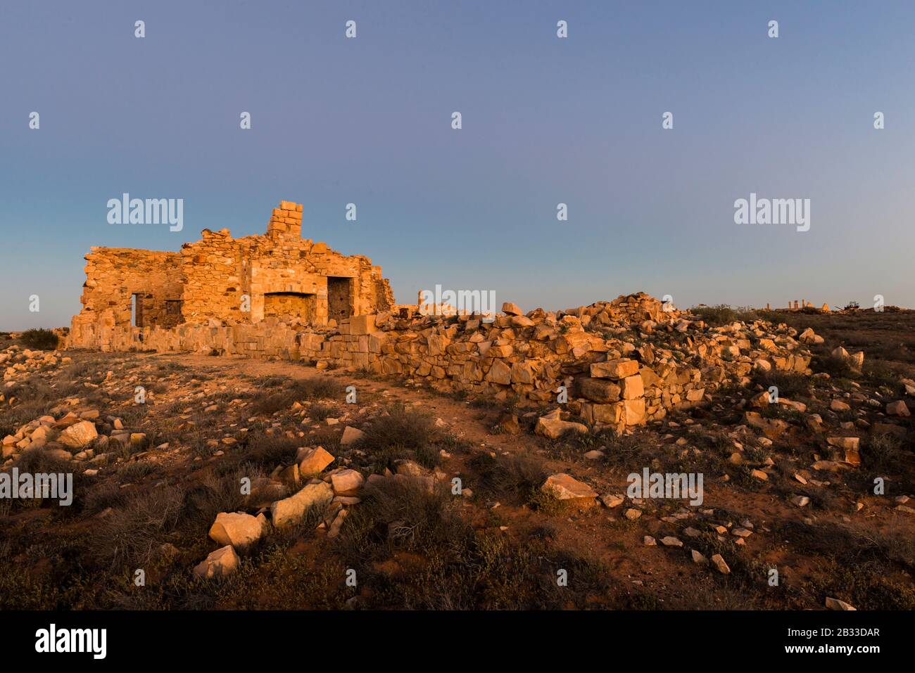 An old ruined building and scattered debris in the ghost town of Farina ...