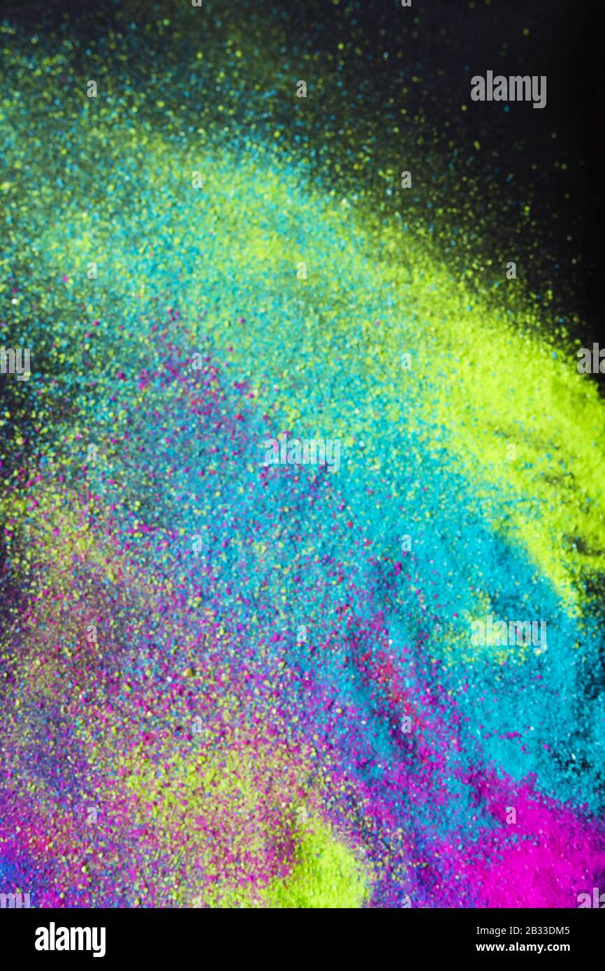 abstract powder splatted on black background, color powder exploding ...