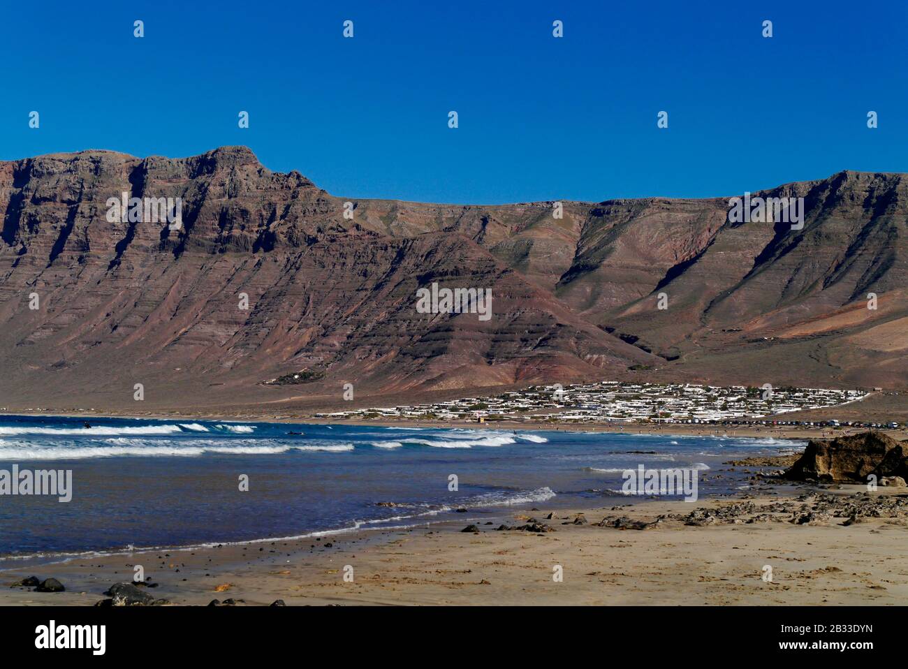 Playa de Famara , a popular surfing beach while the north end is used ...
